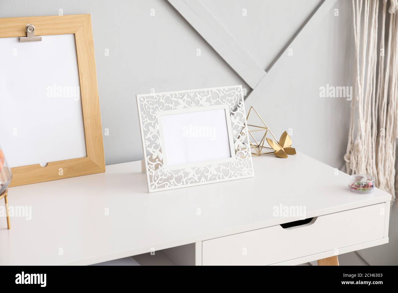 Photo frames on table in room Stock Photo - Alamy