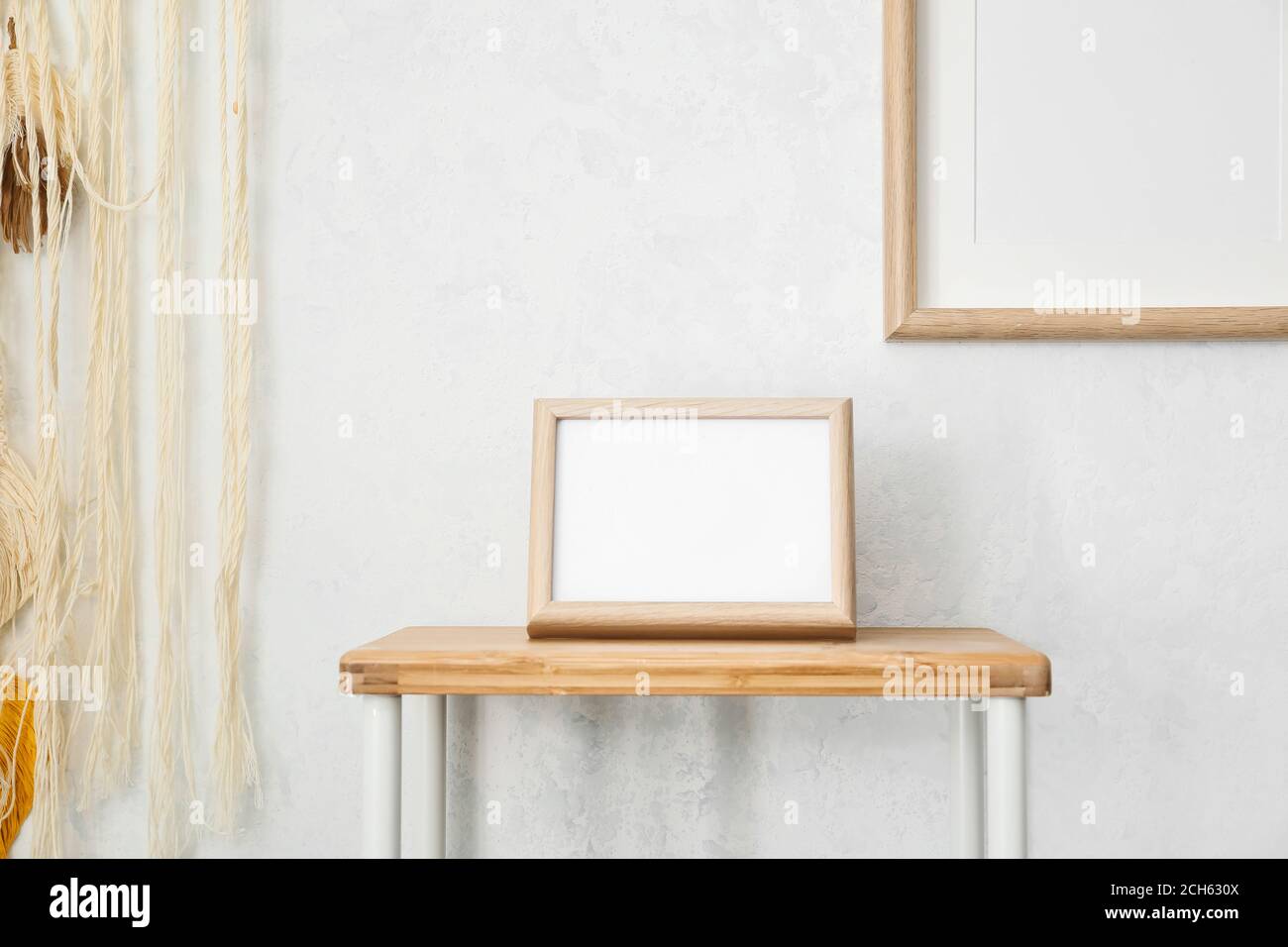 Photo frame on table in room Stock Photo - Alamy