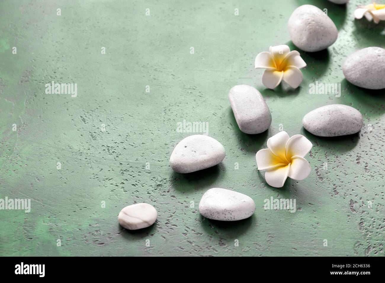Spa stones and flowers on color background. Zen concept Stock Photo - Alamy