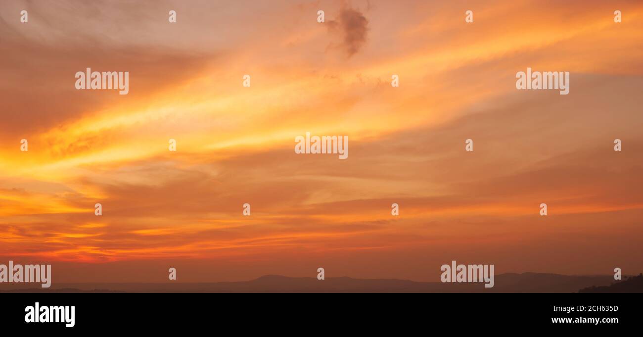 Dramatic sunrise sky over a mountains, abstract ripples clouds on the ...