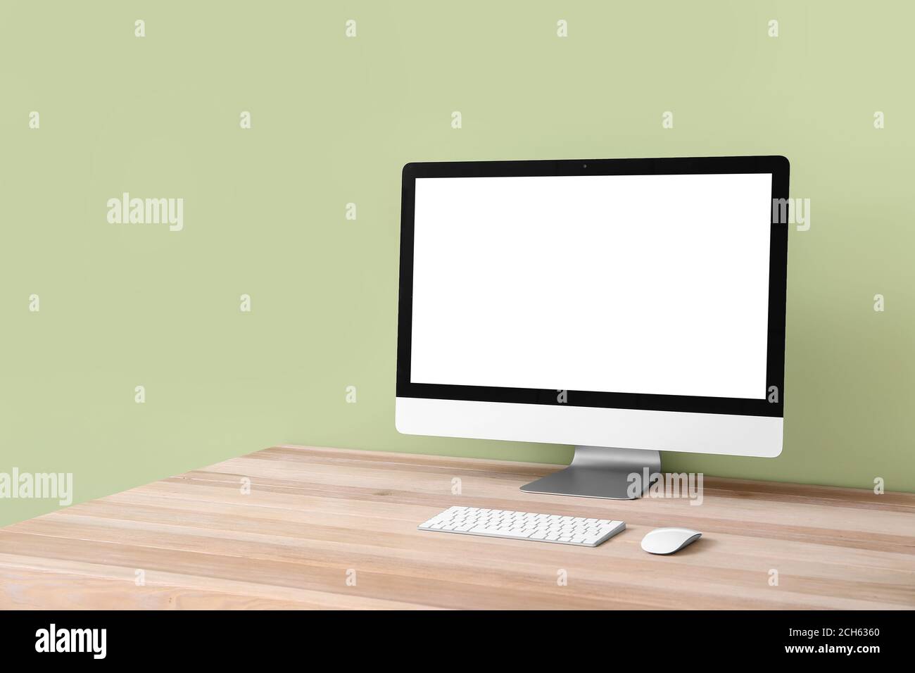 Modern PC monitor on table near color wall Stock Photo - Alamy