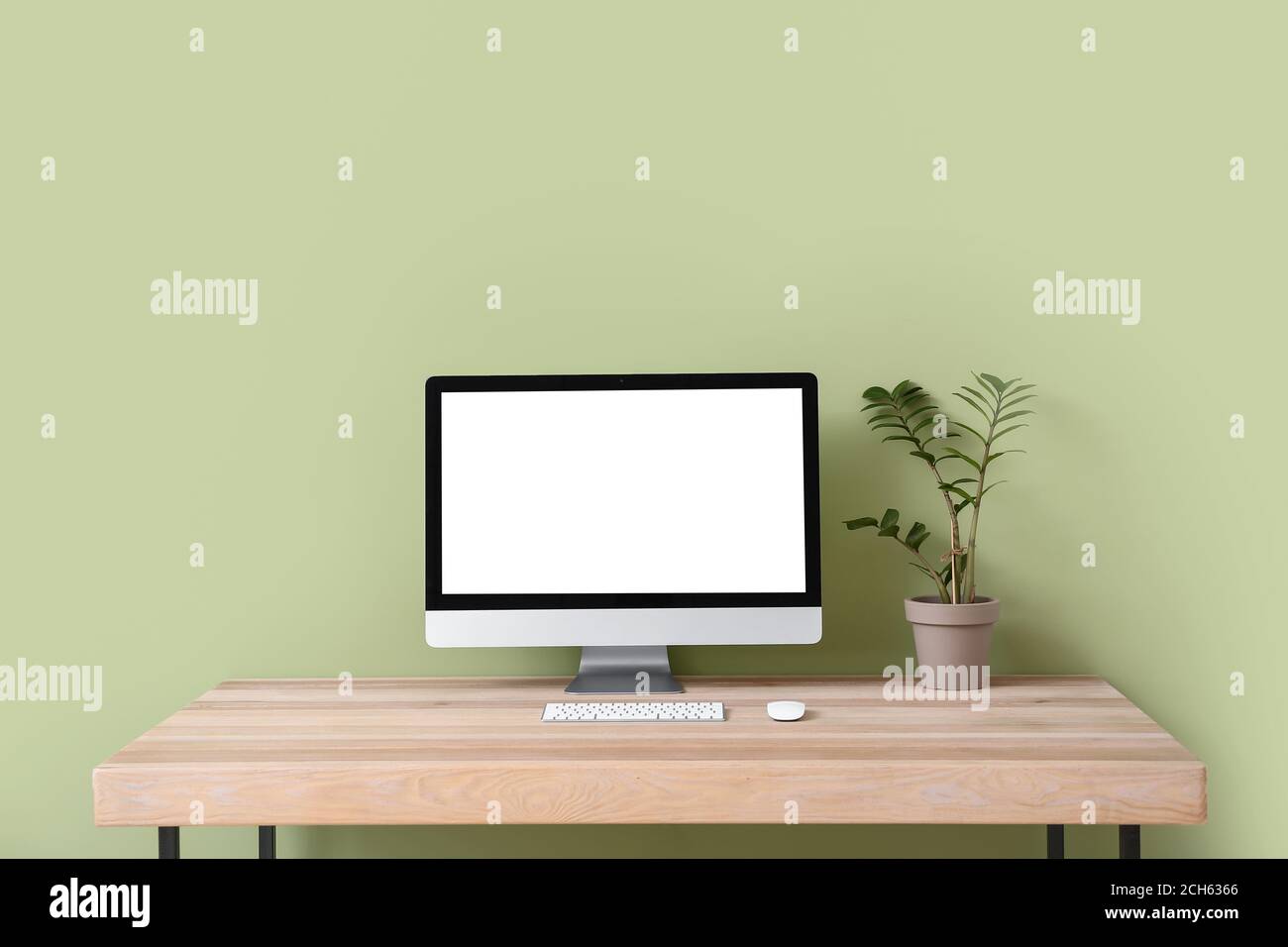 Modern PC monitor on table near color wall Stock Photo - Alamy