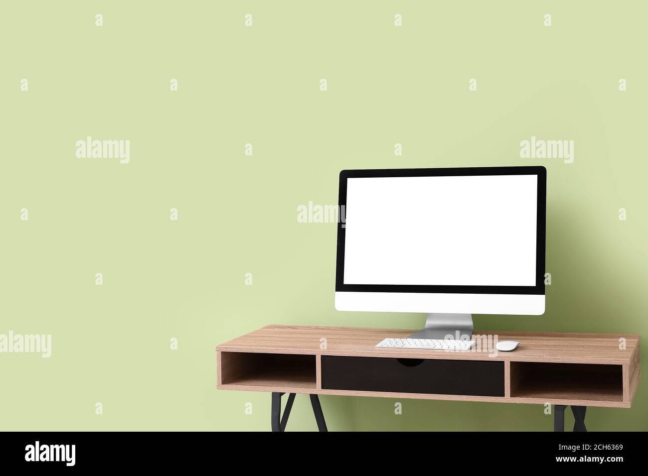 Modern PC monitor on table near color wall Stock Photo - Alamy