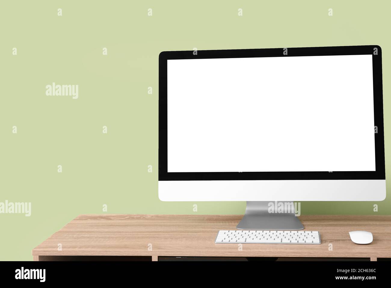 Modern PC monitor on table near color wall Stock Photo - Alamy