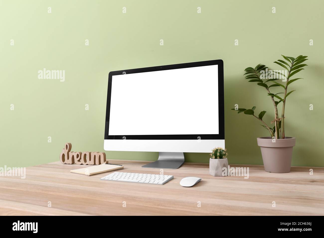 Modern PC monitor on table near color wall Stock Photo - Alamy
