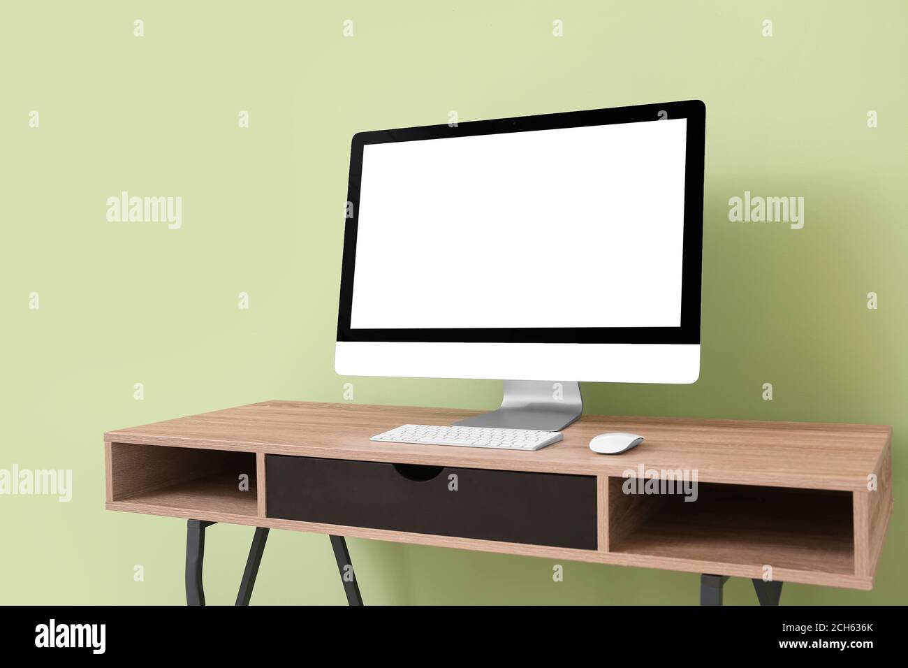 Modern PC monitor on table near color wall Stock Photo - Alamy