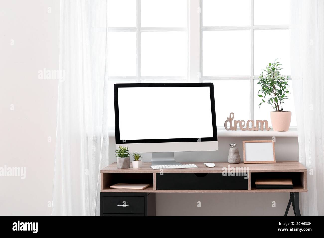 Modern workplace with computer near window in room Stock Photo - Alamy