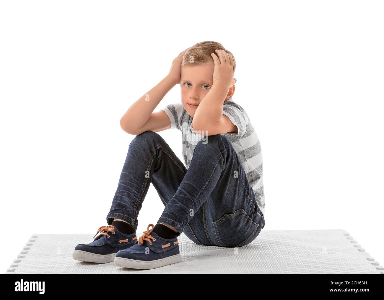 Sad little boy with autistic disorder on white background Stock Photo ...