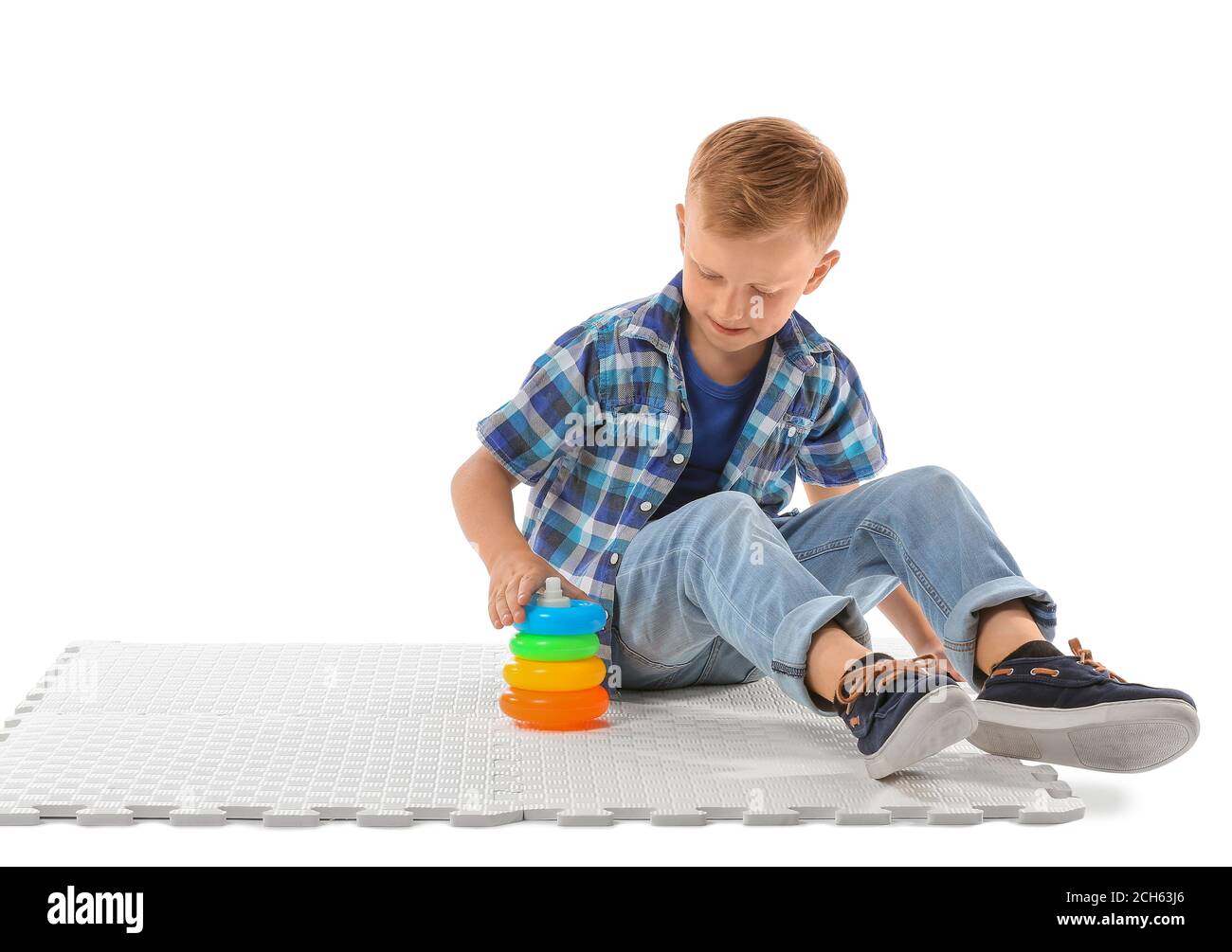 Little boy with autistic disorder playing with toy on white background ...