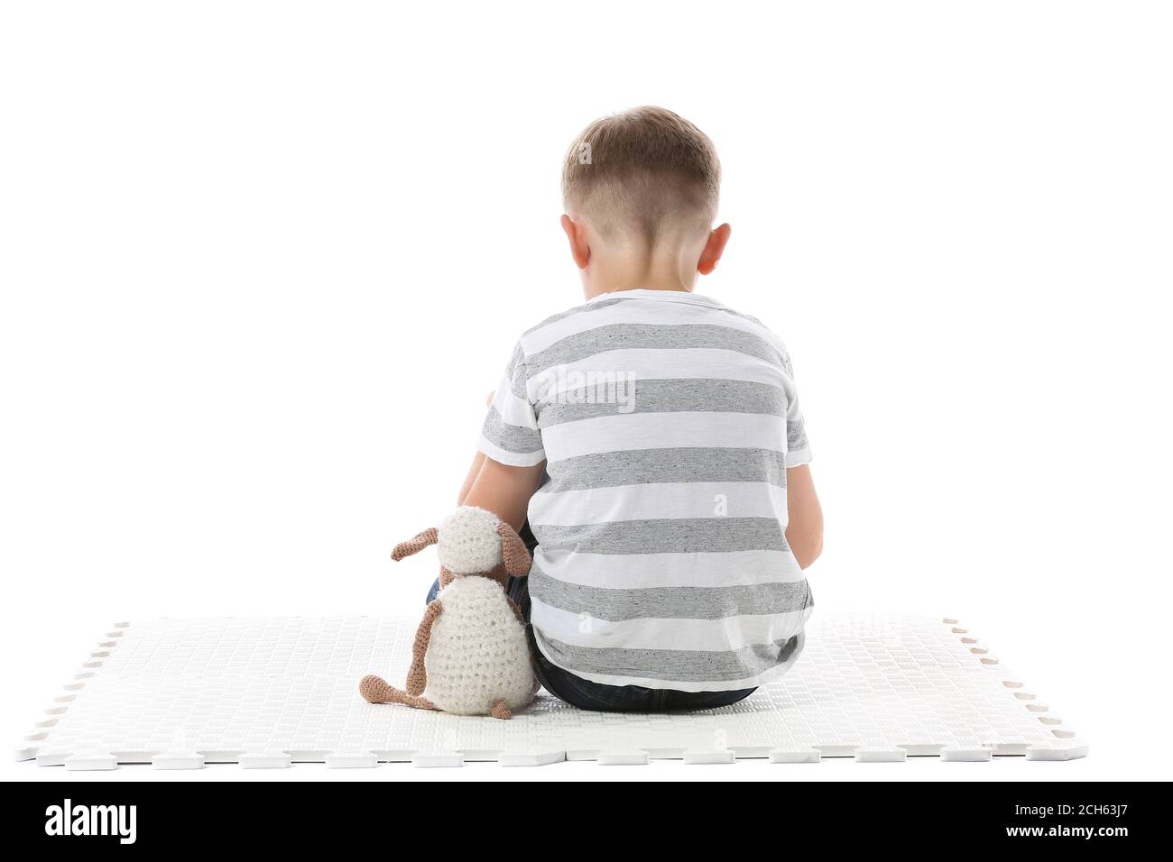 Sad little boy with autistic disorder on white background, back view ...