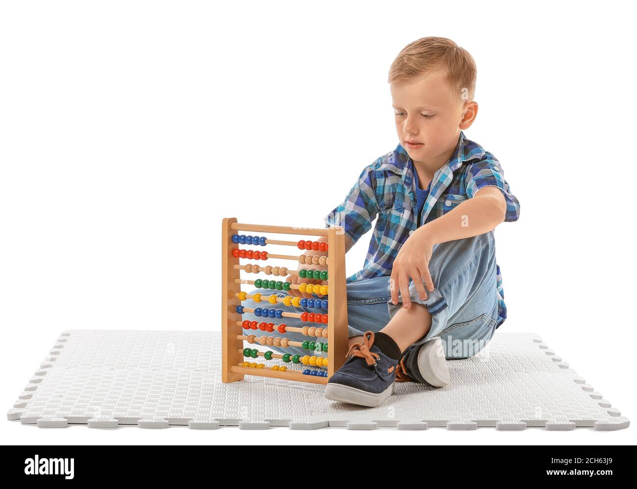 Little boy with autistic disorder playing with abacus on white ...