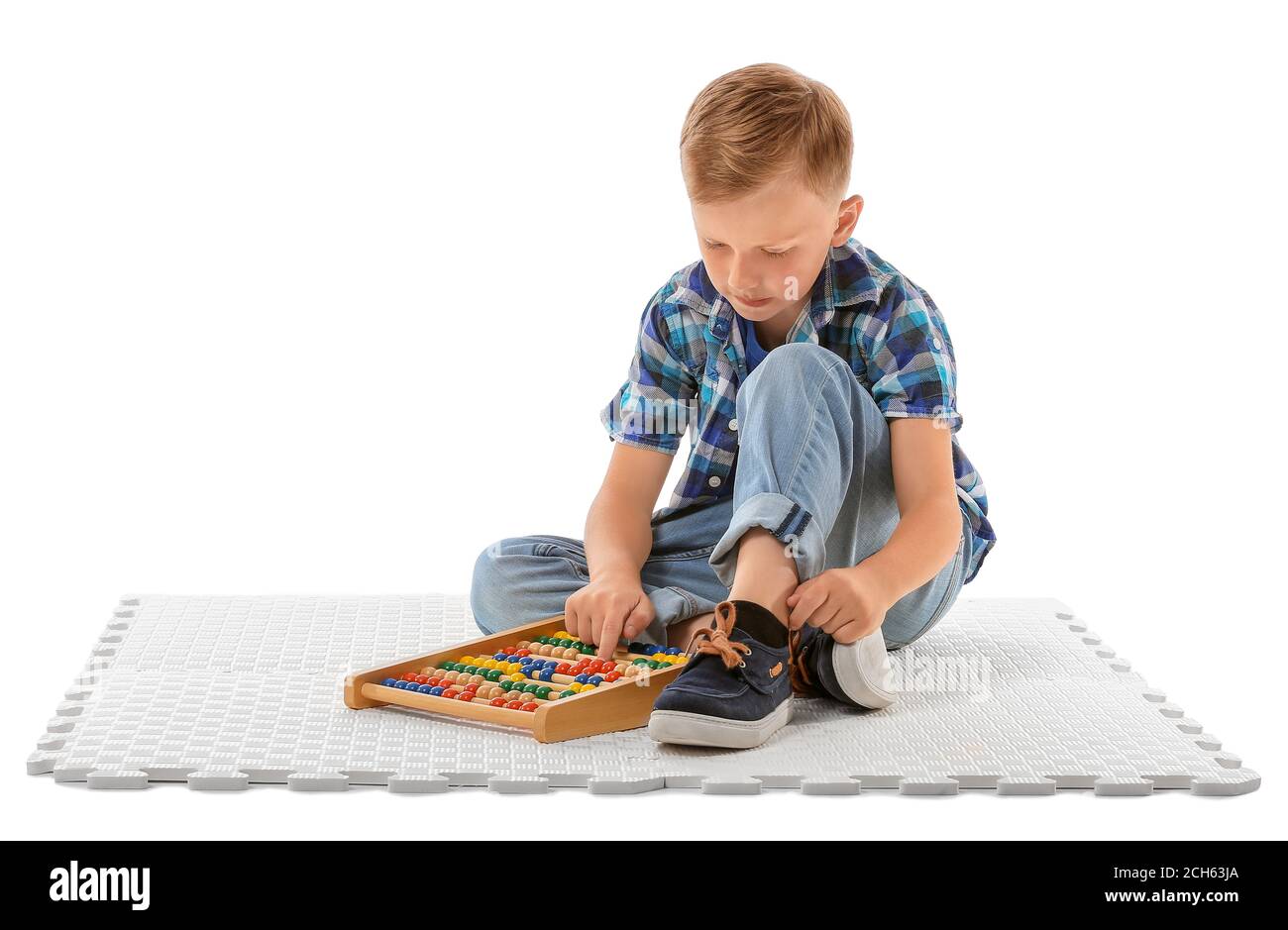 Little boy with autistic disorder playing with abacus on white ...
