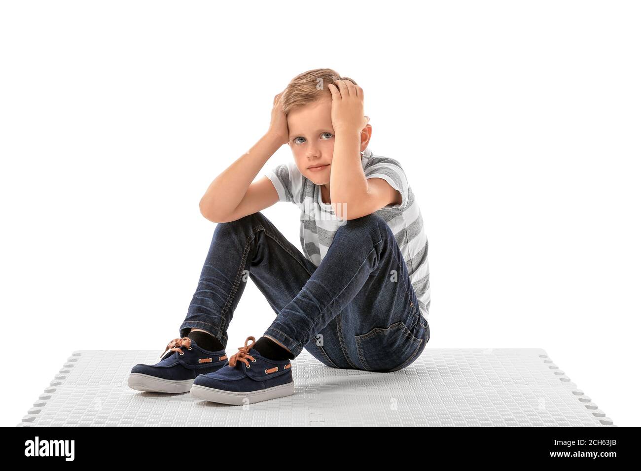 Sad little boy with autistic disorder on white background Stock Photo ...