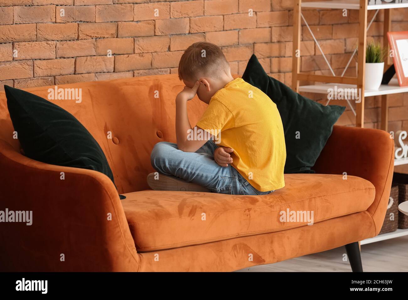 Sad little boy with autistic disorder at home Stock Photo - Alamy