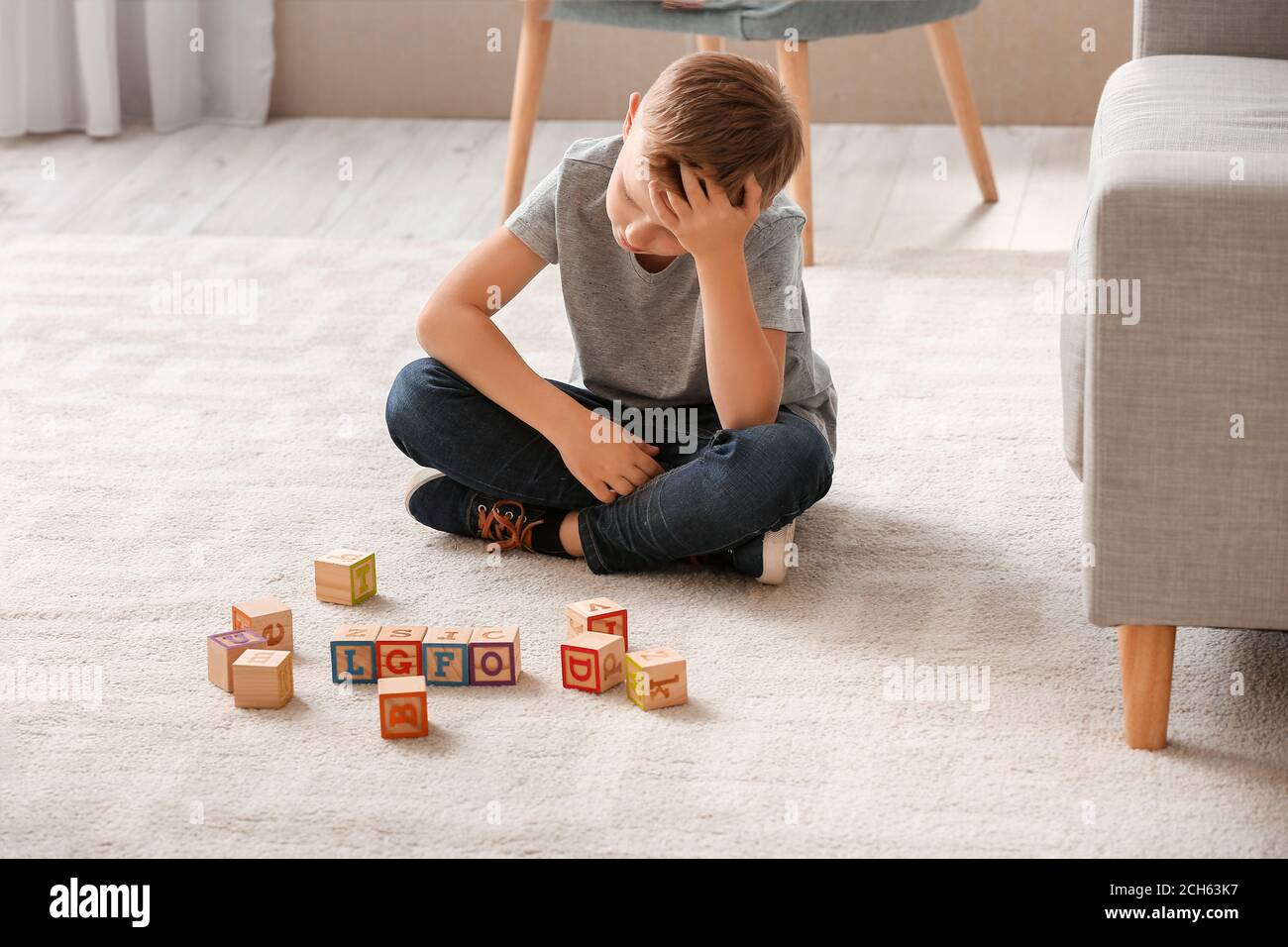 Little boy with autistic disorder playing with cubes at home Stock ...