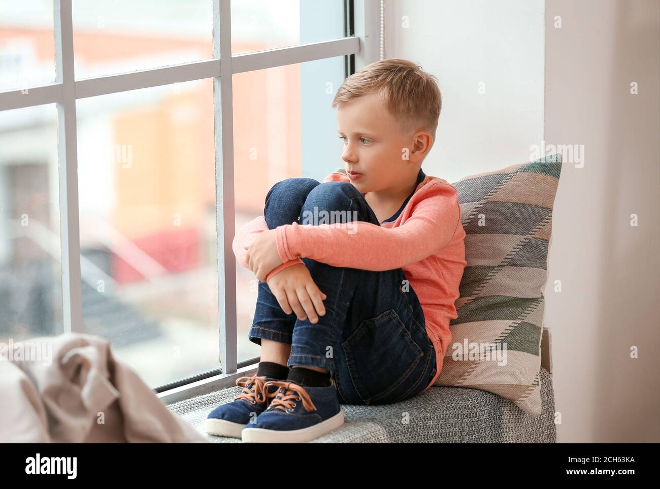 Little boy with autistic disorder sitting near window at home Stock ...