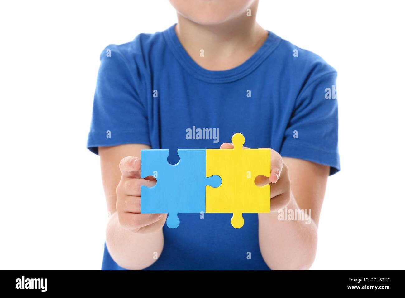 Little boy with autistic disorder and with puzzle pieces on white ...