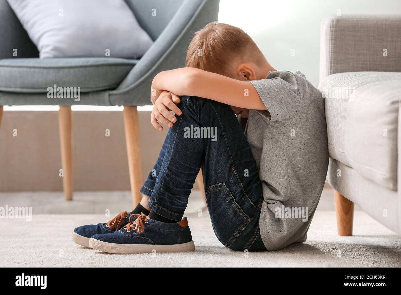 Sad little boy with autistic disorder at home Stock Photo - Alamy