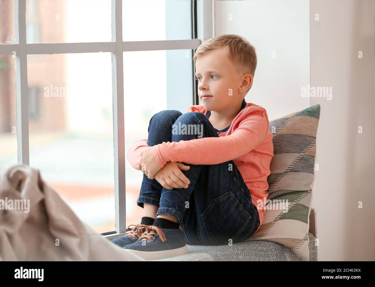 Little boy with autistic disorder sitting near window at home Stock ...