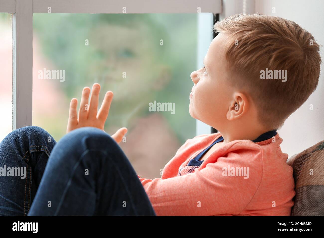 Little boy with autistic disorder sitting near window at home Stock ...