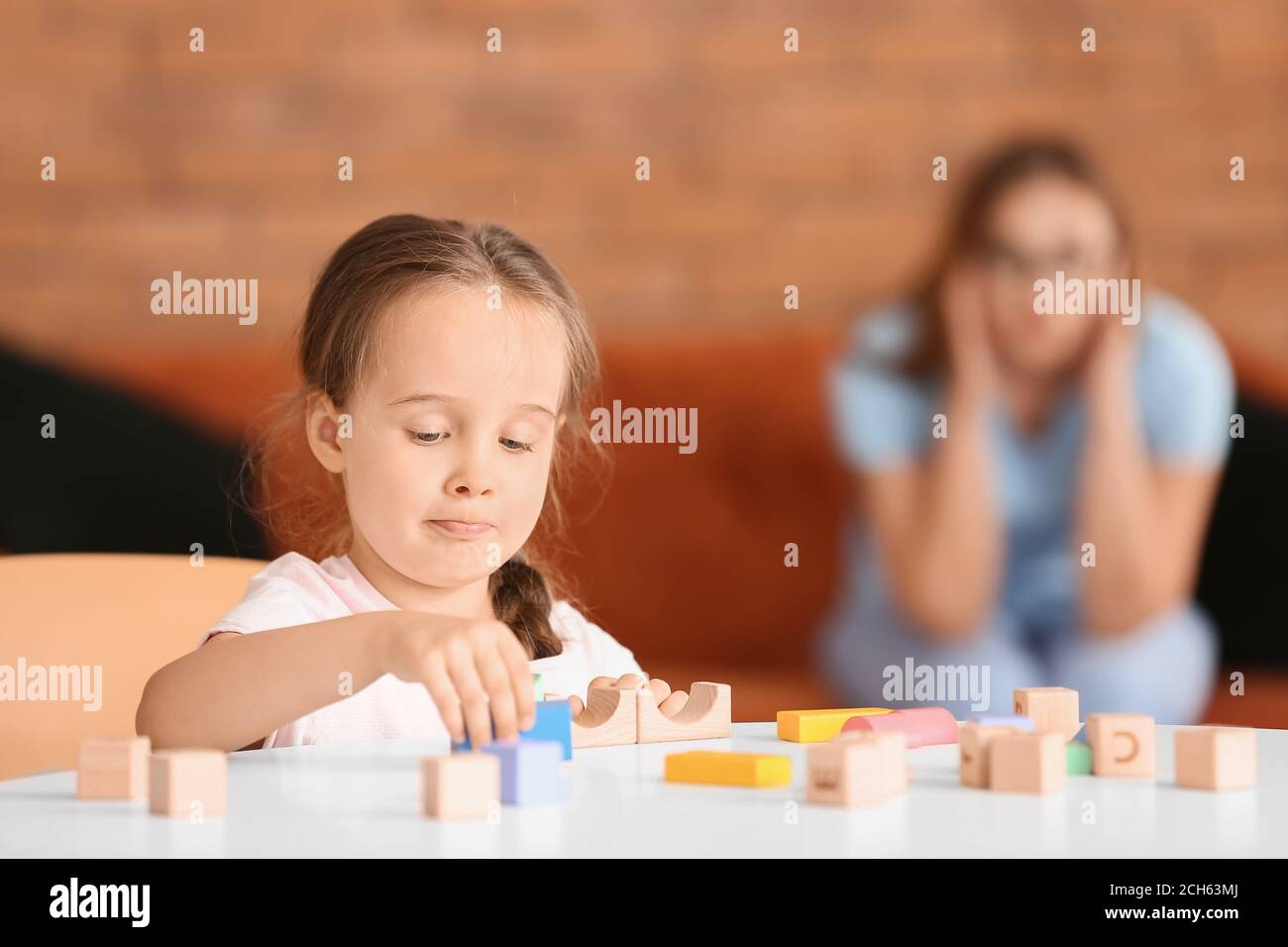 Little girl with autistic disorder playing with blocks at home Stock ...