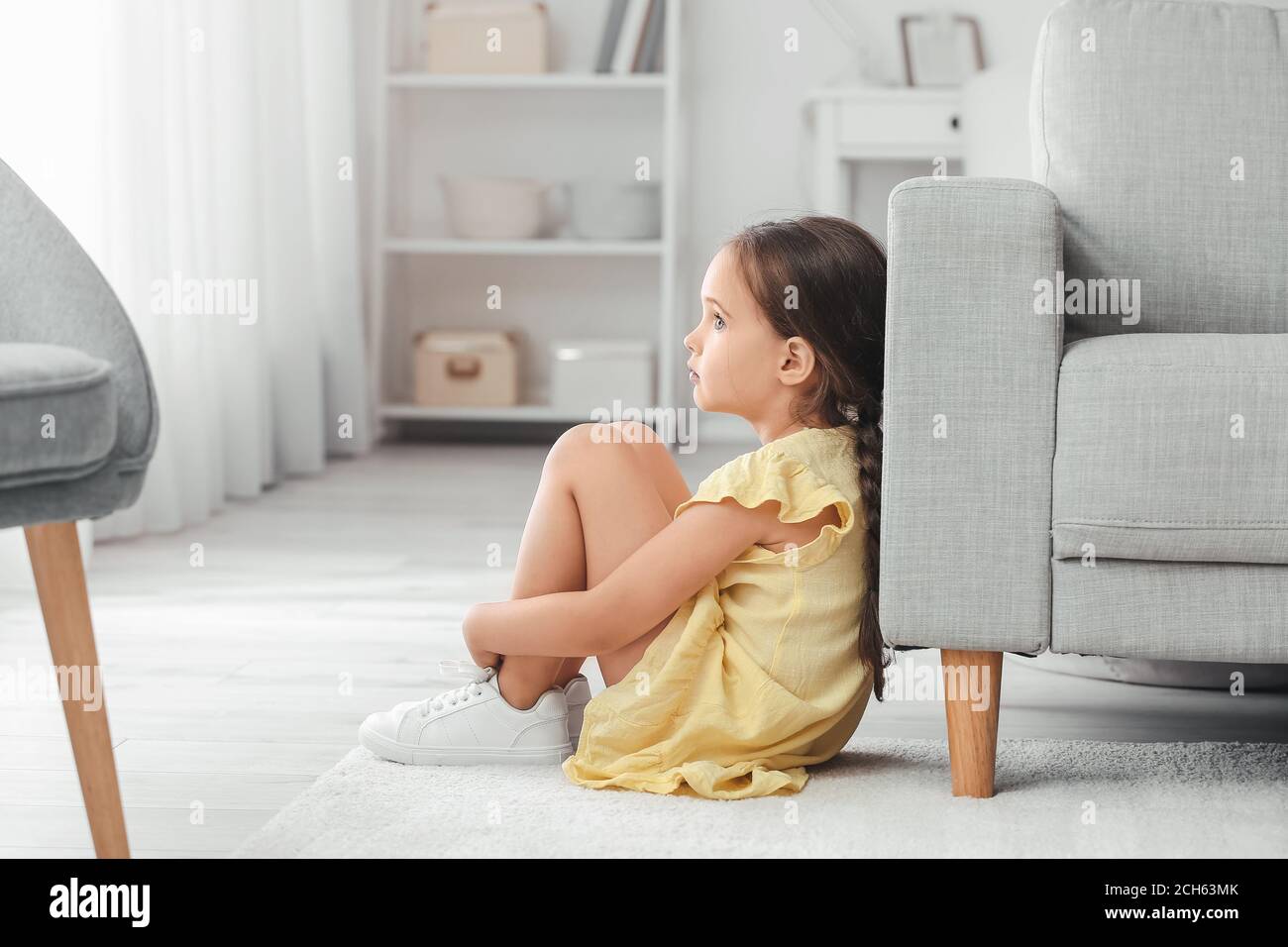 Sad little girl with autistic disorder at home Stock Photo - Alamy