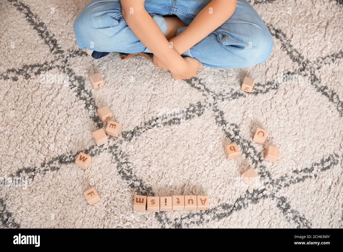 Little boy with autistic disorder playing with cubes at home Stock ...