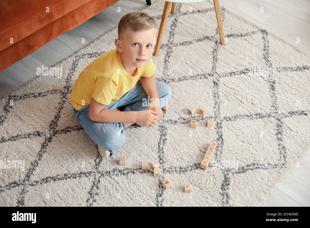 Little boy with autistic disorder playing with cubes at home Stock ...