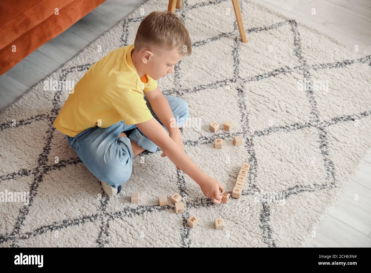 Little boy with autistic disorder playing with cubes at home Stock ...