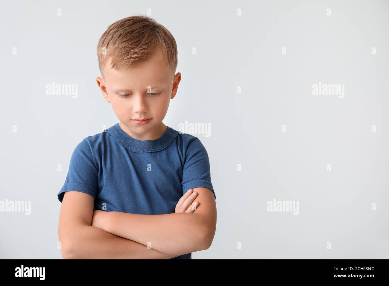 Sad little boy with autistic disorder on light background Stock Photo ...