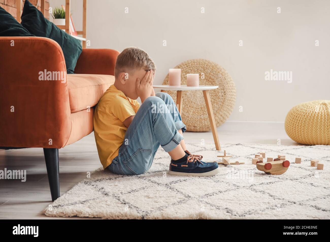 Sad little boy with autistic disorder at home Stock Photo - Alamy