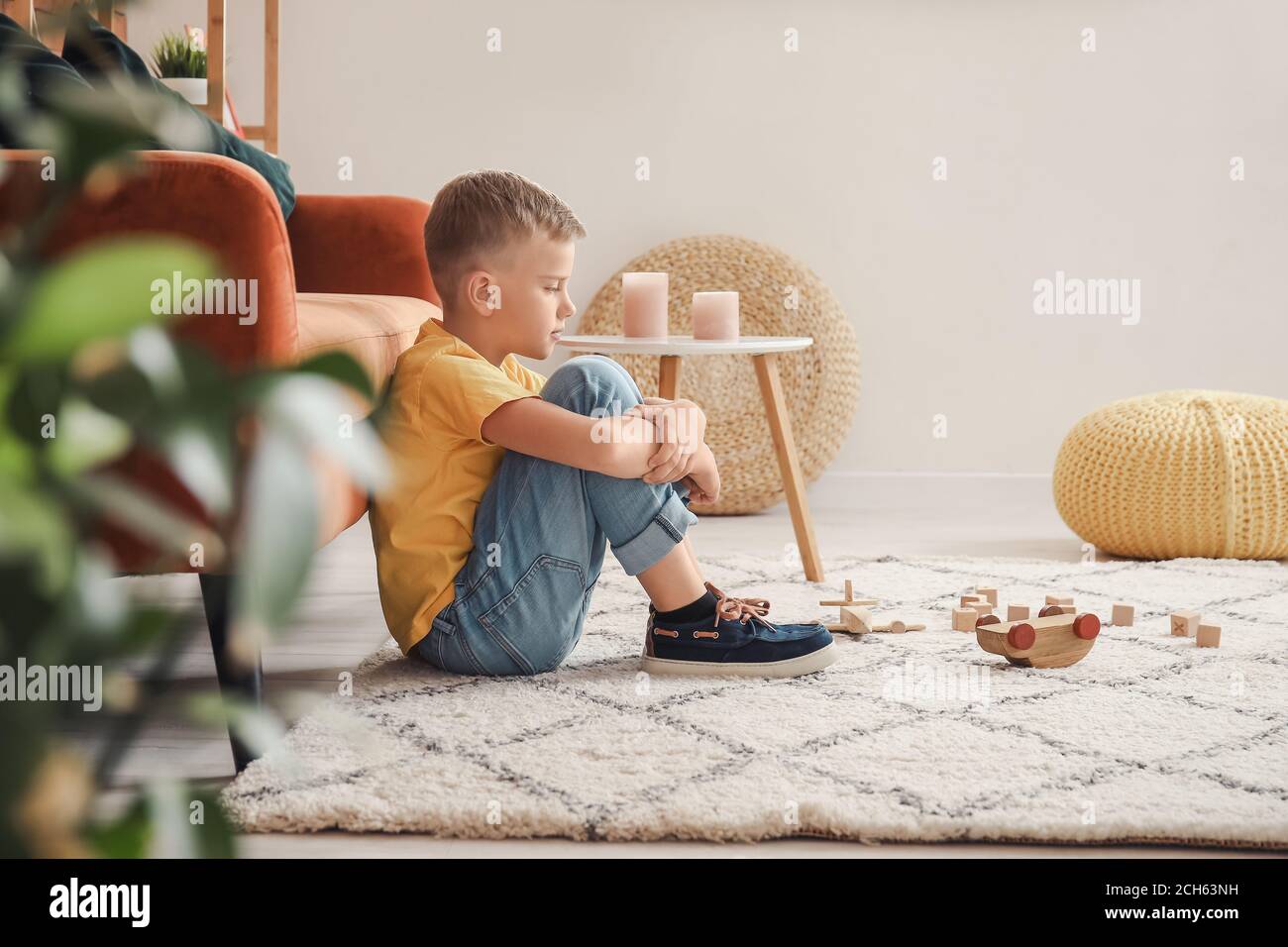 Sad little boy with autistic disorder at home Stock Photo - Alamy