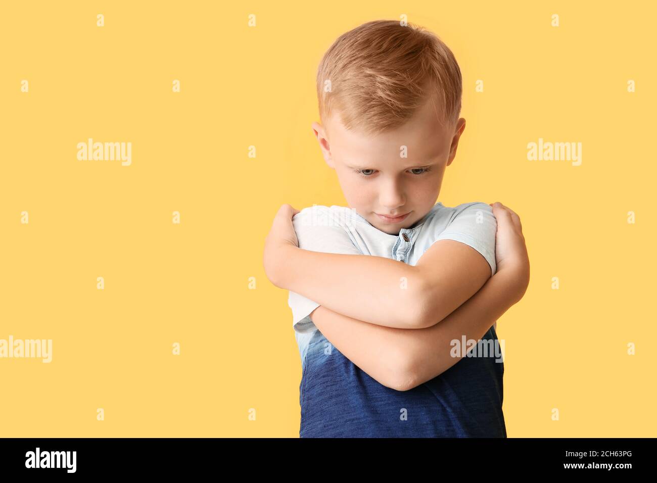 Sad little boy with autistic disorder on color background Stock Photo ...