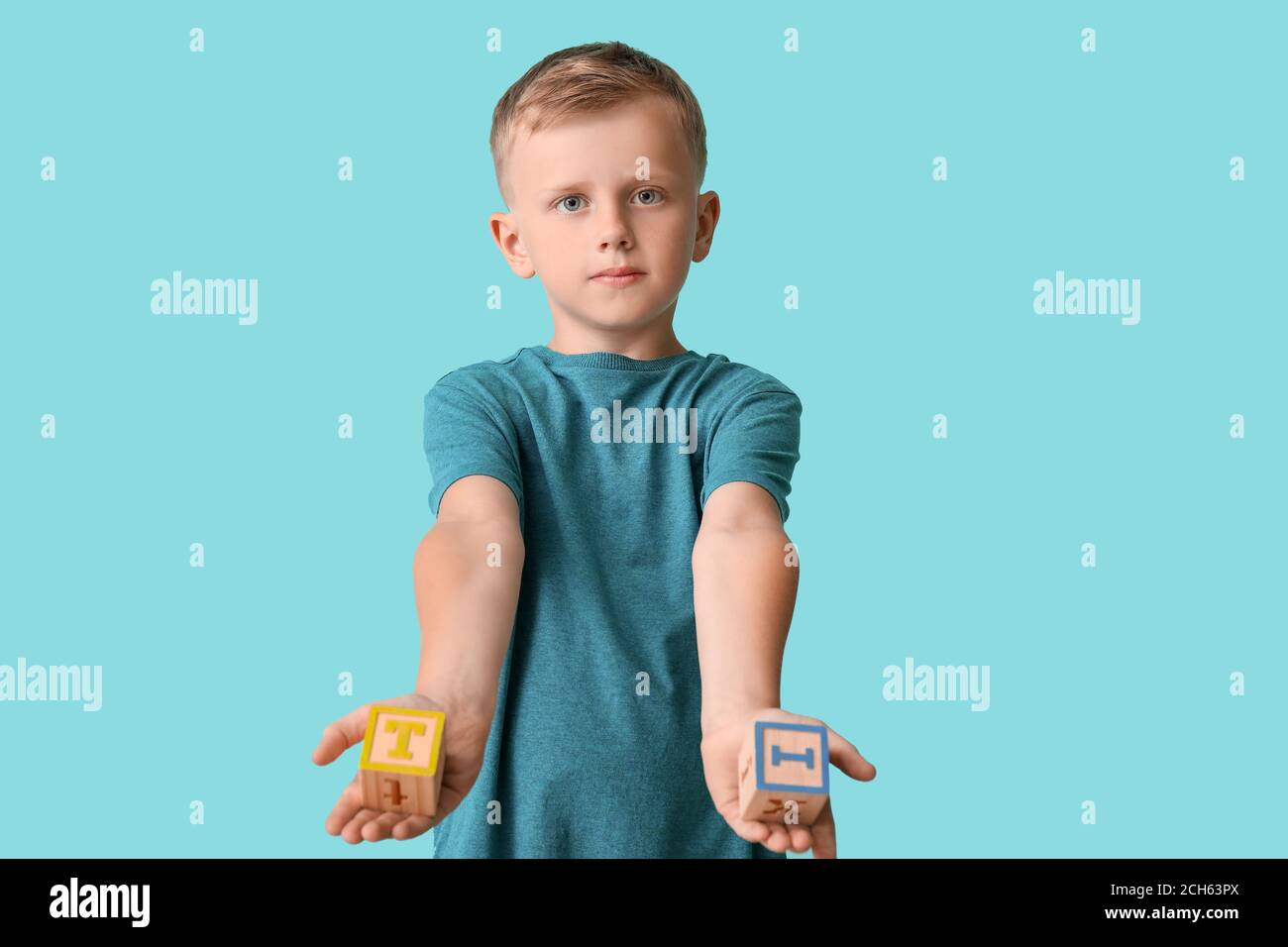 Little boy with autistic disorder and cubes on color background Stock ...