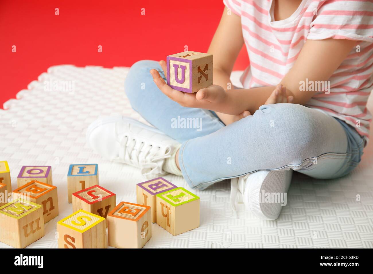 Little girl with autistic disorder playing with cubes Stock Photo - Alamy