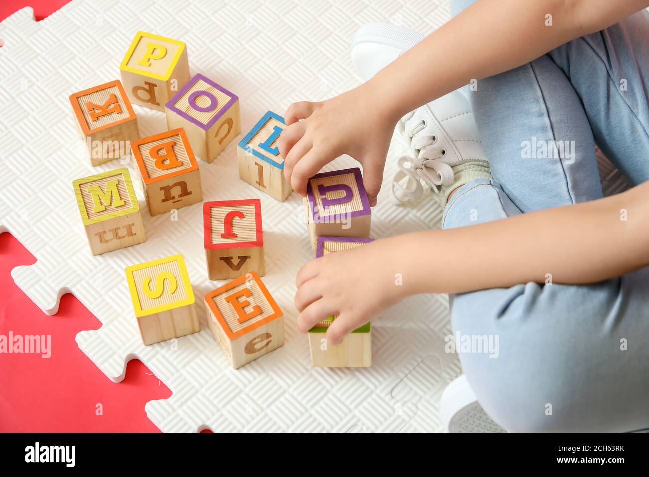 Little girl with autistic disorder playing with cubes Stock Photo - Alamy