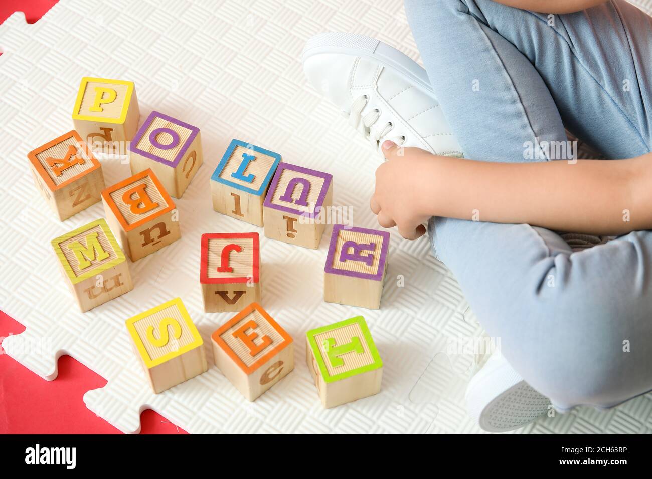 Little girl with autistic disorder playing with cubes Stock Photo - Alamy