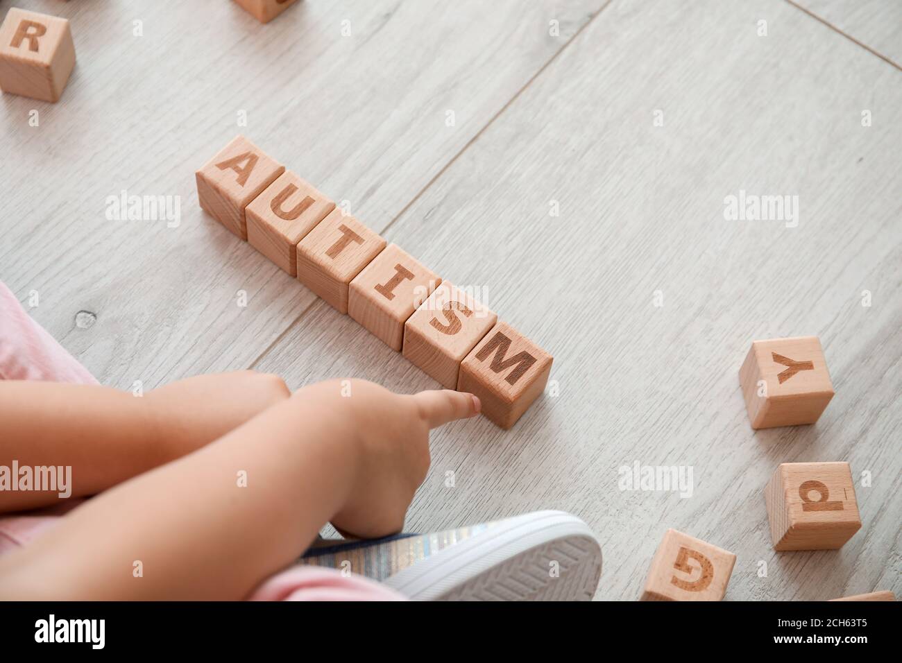 Little girl with autistic disorder playing with cubes on floor Stock ...