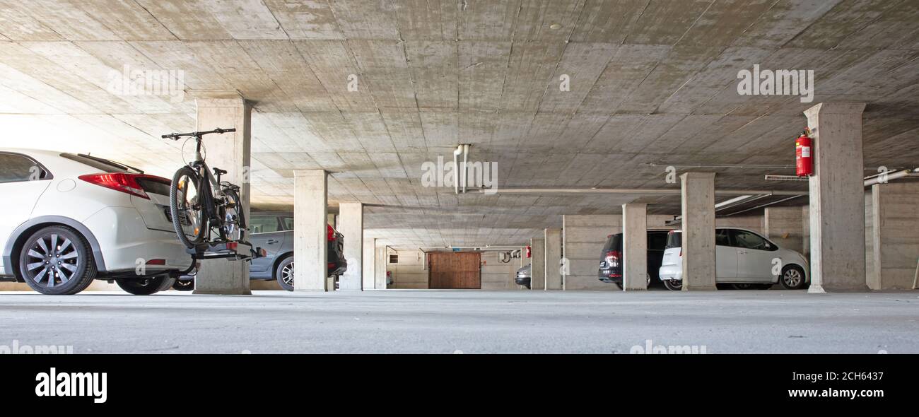 Parking garage underground, unwelcoming concrete walls, selective focus ...