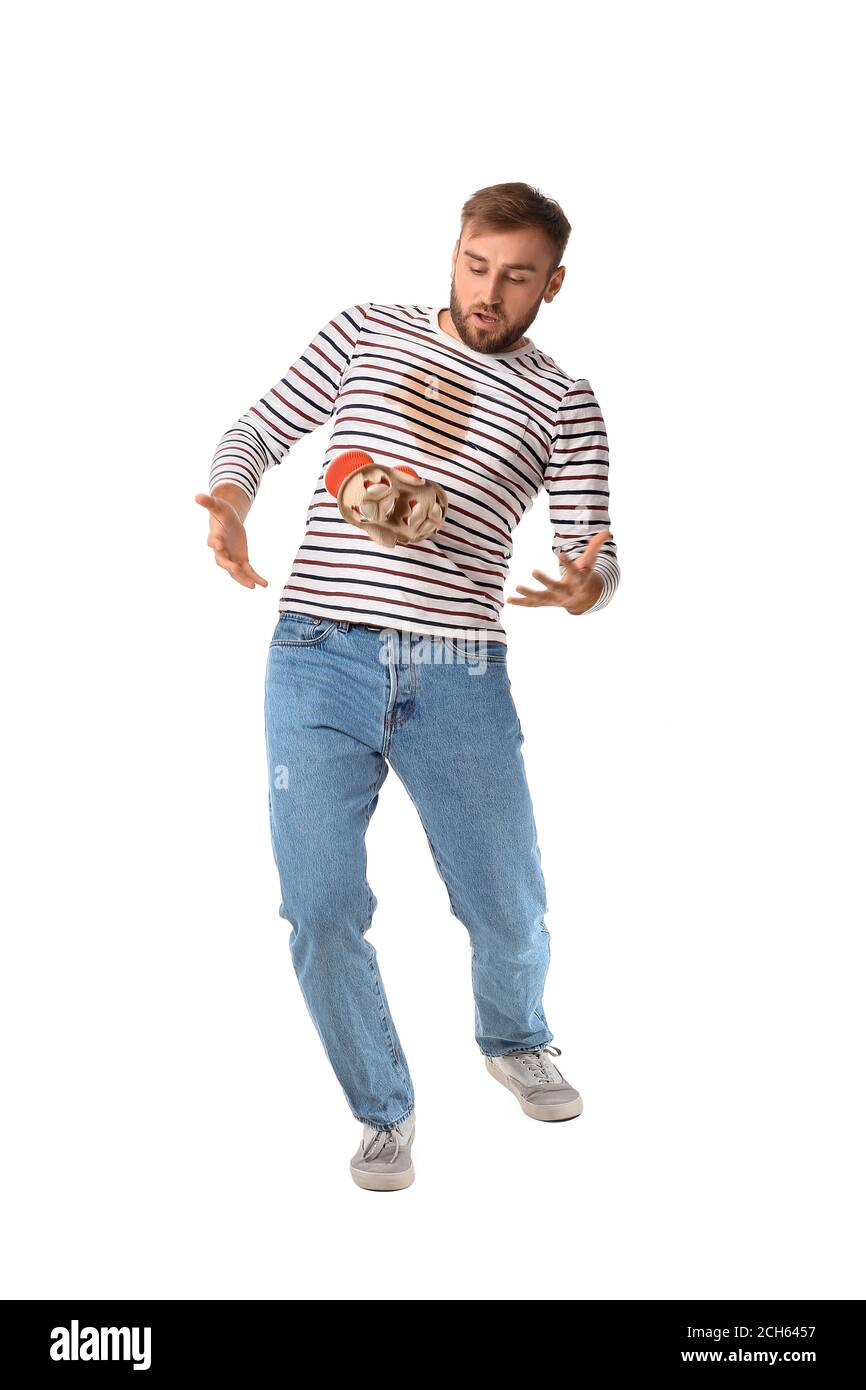 Stressed young man dropping cups of coffee on white background Stock ...