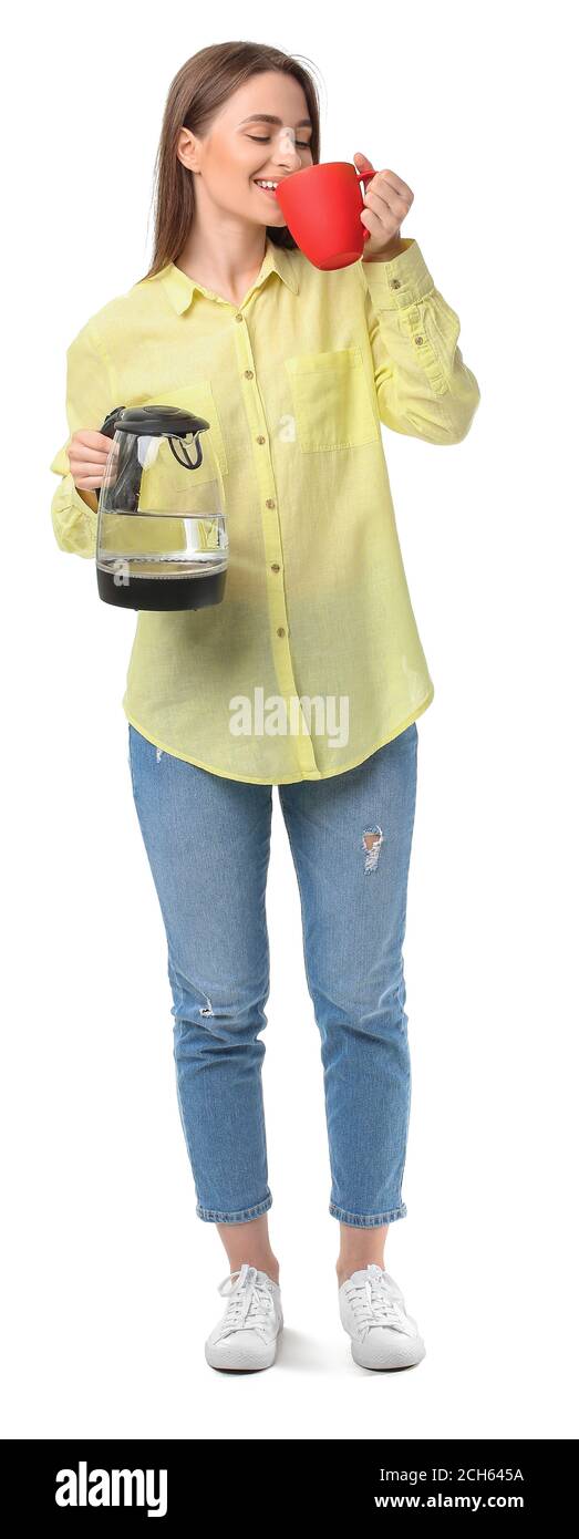 Young woman with electric kettle drinking tea on white background Stock ...