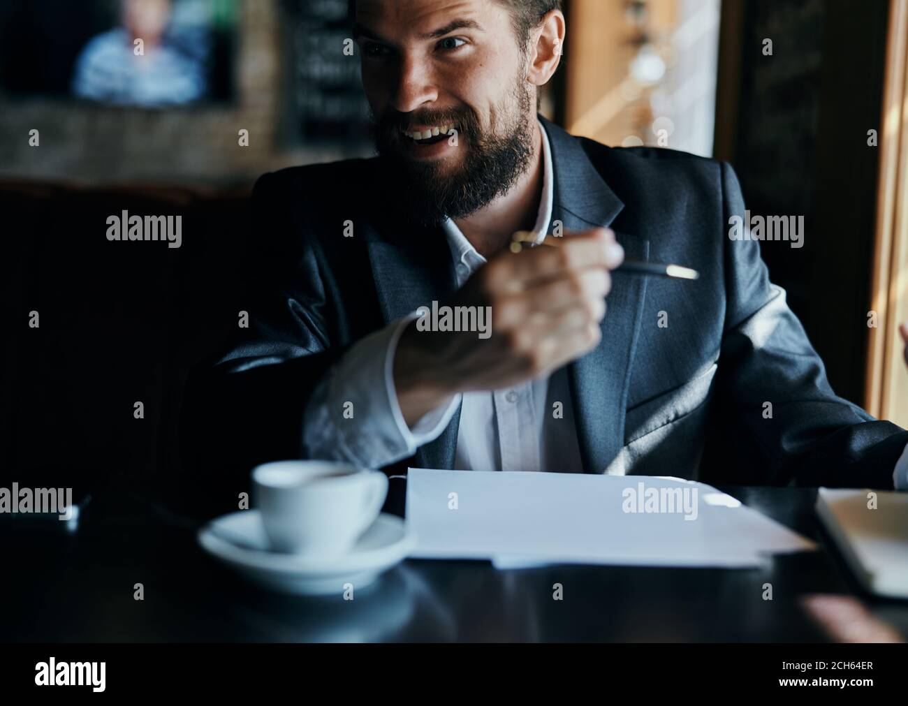 business man sitting at a table in a cafe documents work official ...