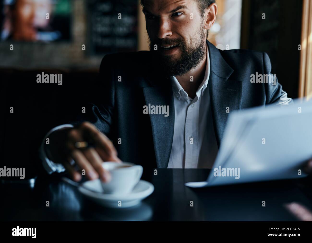 business man sitting at a table in a cafe documents work official ...