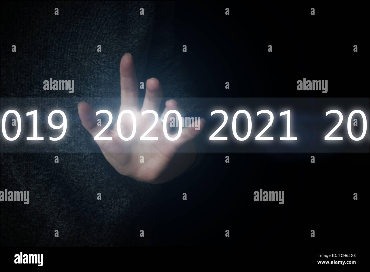Luminous 2020 year numbers and network above hand at black background ...