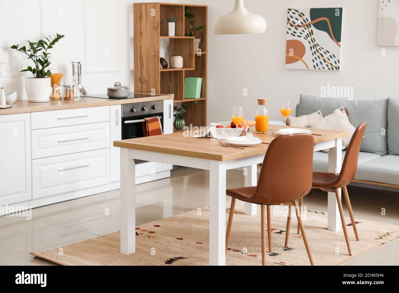 Interior of modern stylish kitchen with dining table Stock Photo - Alamy