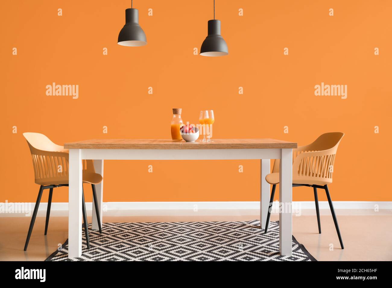 Dining table near color wall Stock Photo - Alamy
