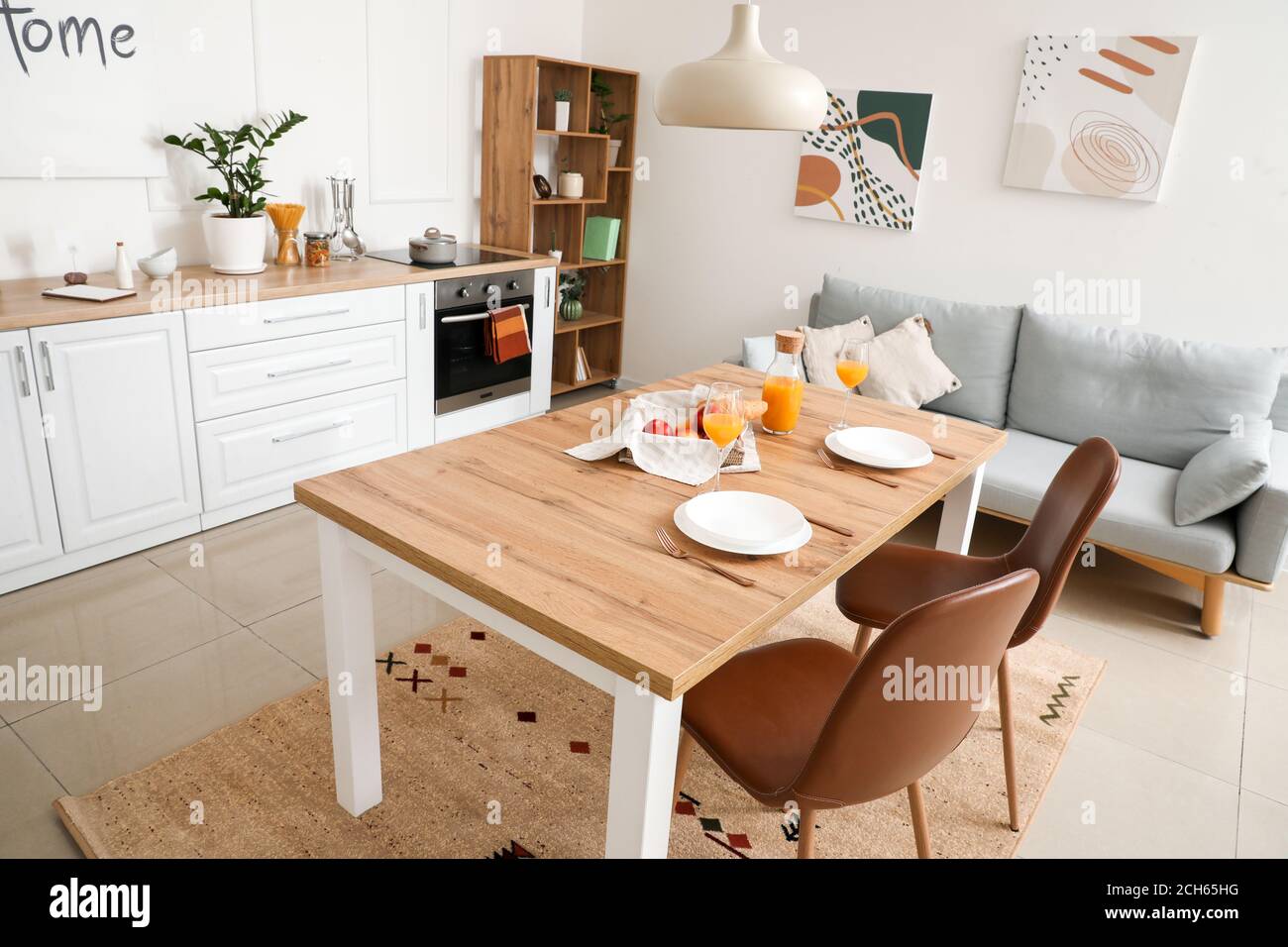 Interior of modern stylish kitchen with dining table Stock Photo - Alamy