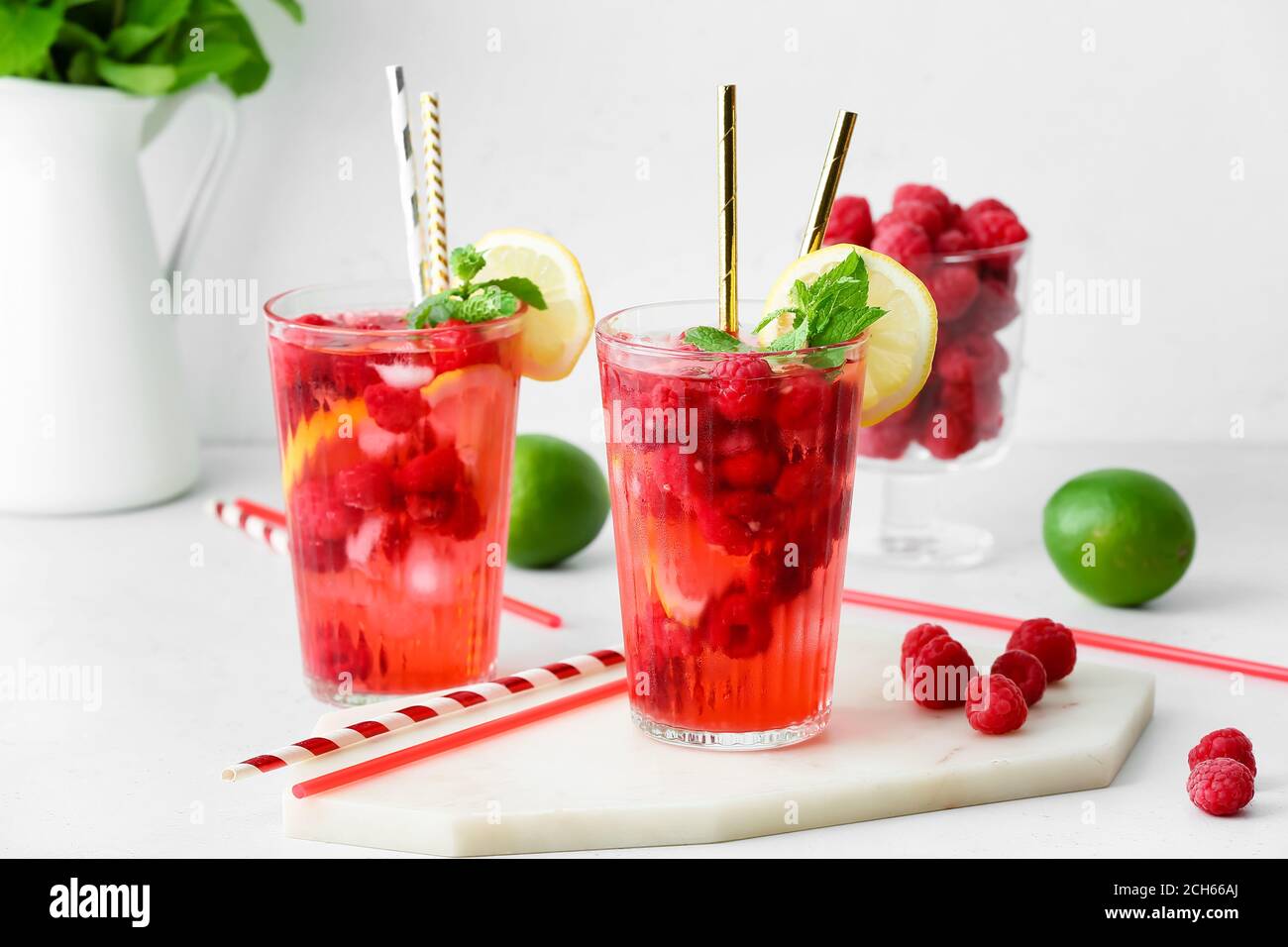 Glasses of cold raspberry tea on white background Stock Photo - Alamy