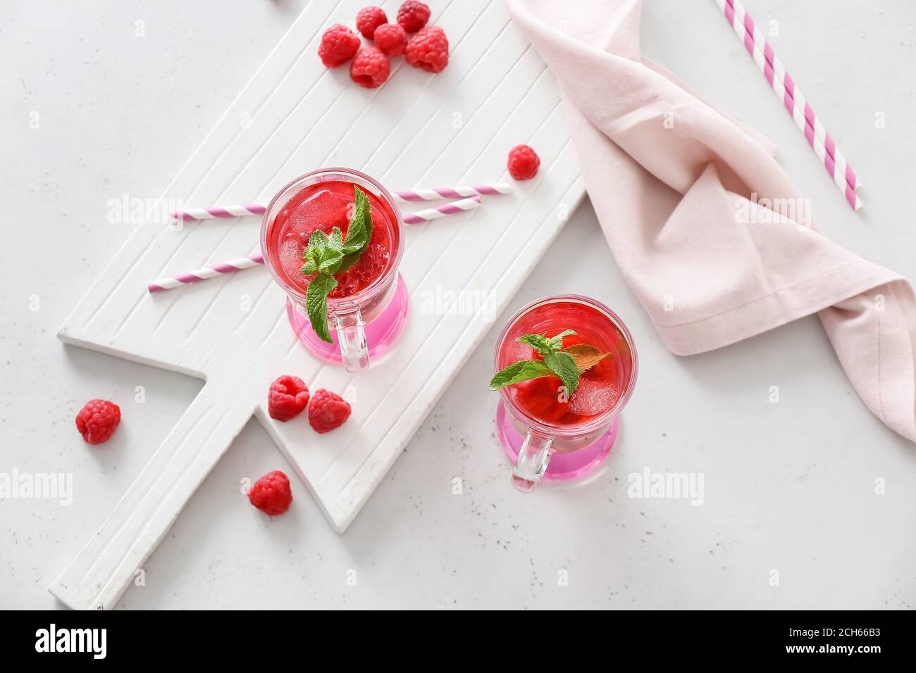 Cups of cold raspberry tea on white background Stock Photo - Alamy