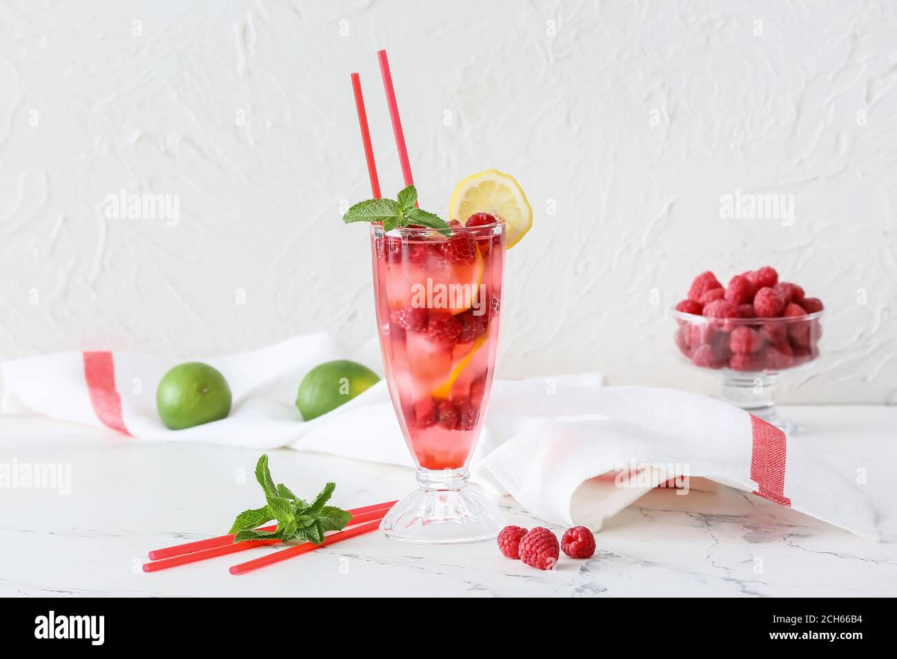 Glass of cold raspberry tea on white background Stock Photo - Alamy